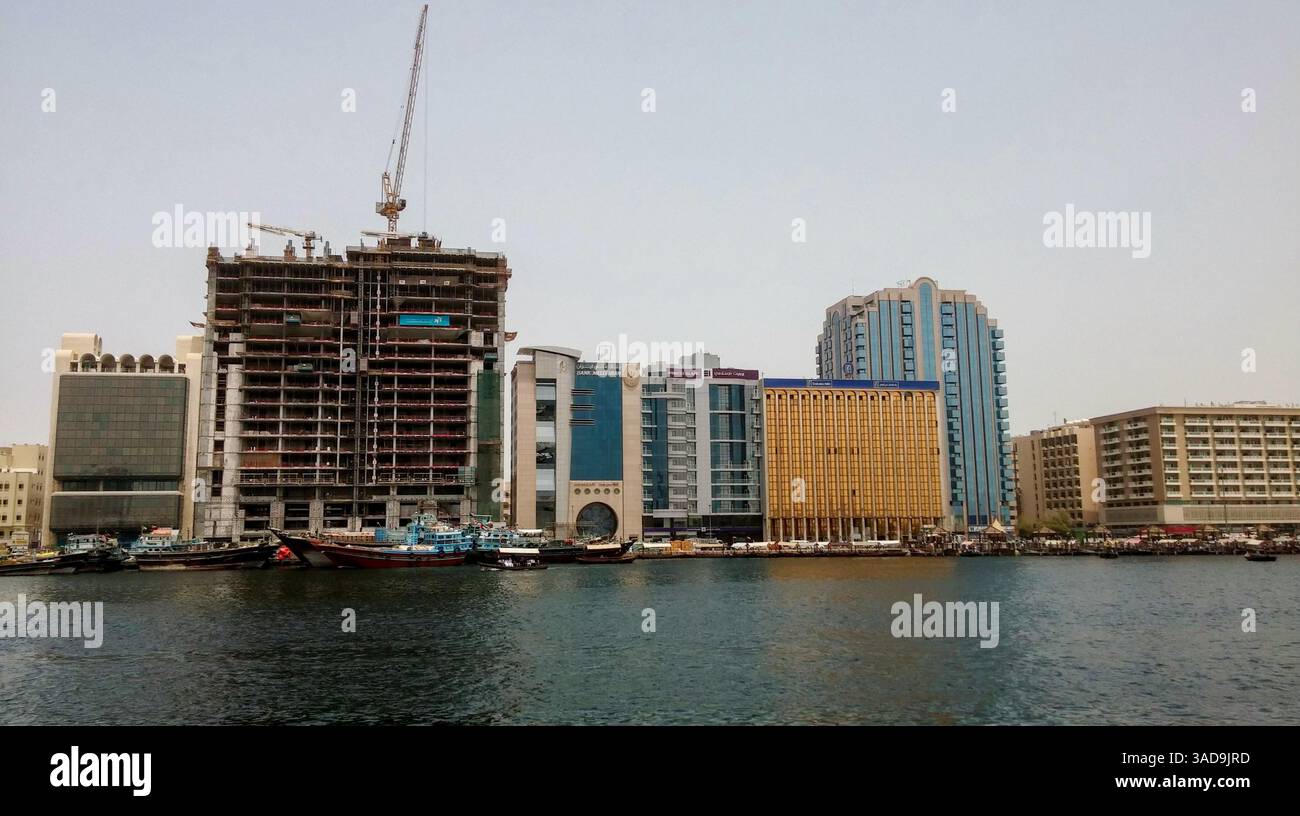 A waterfront view of a city skyline featuring a mix of modern buildings ...