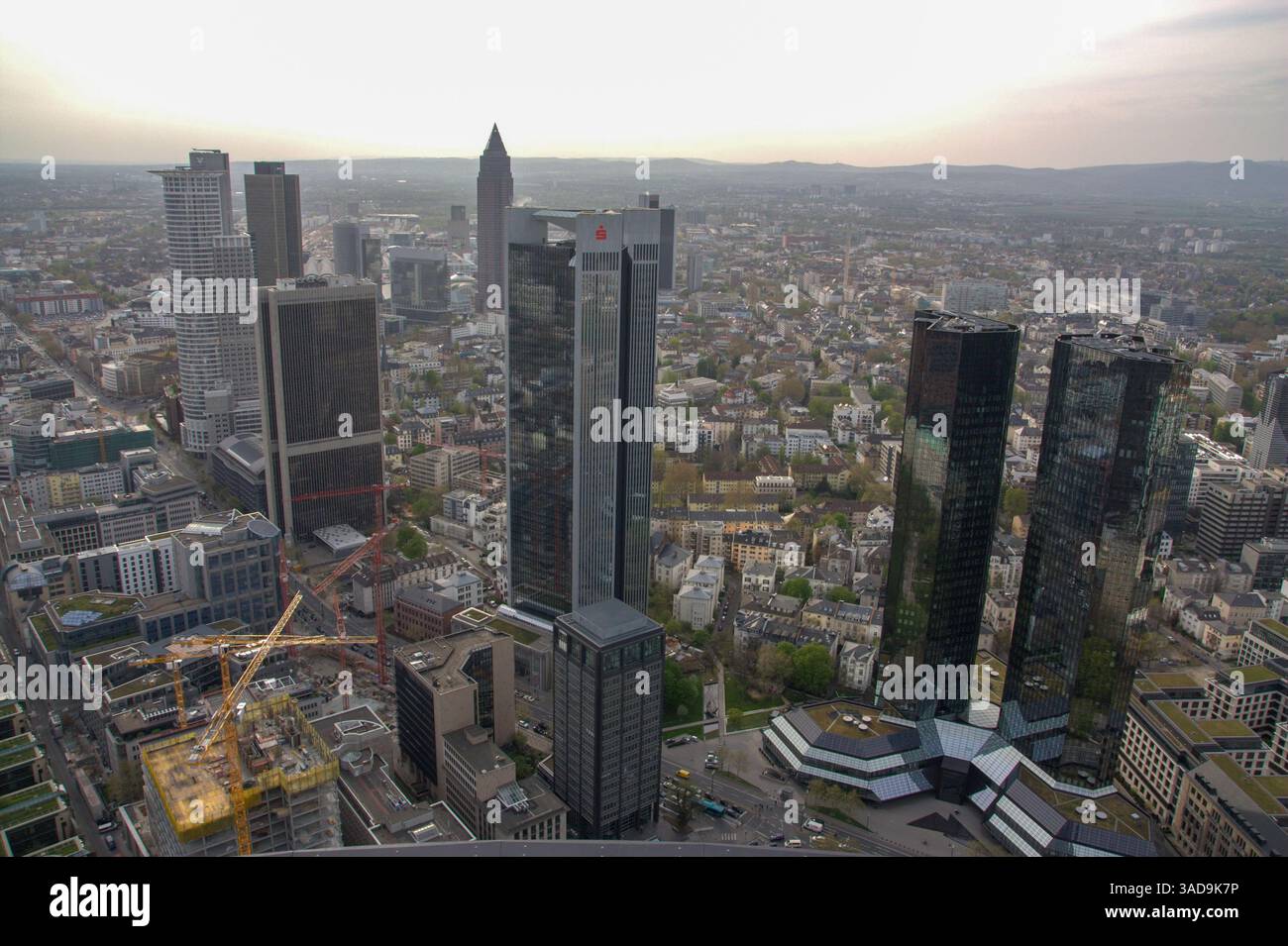 Aerial view of a modern city skyline featuring tall skyscrapers, green ...
