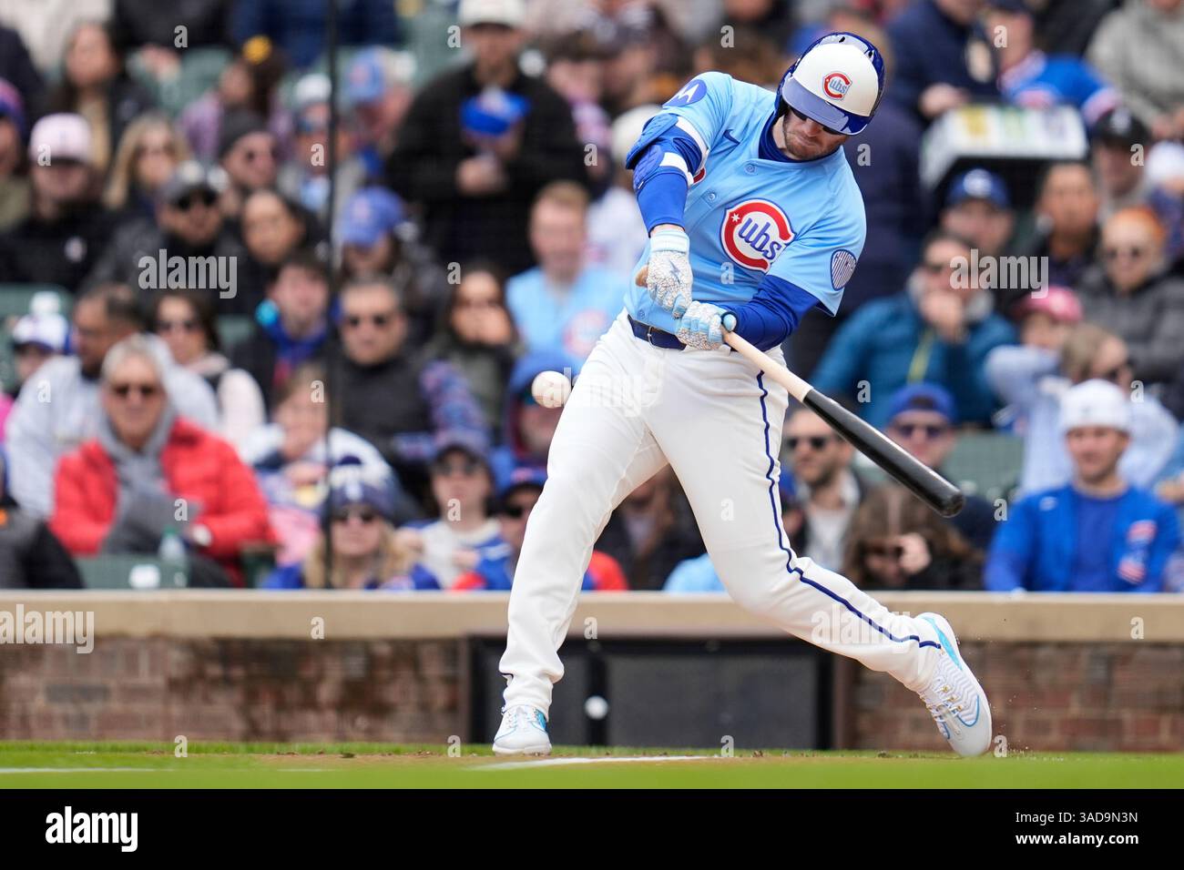Chicago Cubs' Ian Happ (8) hits a double during the first inning of a ...