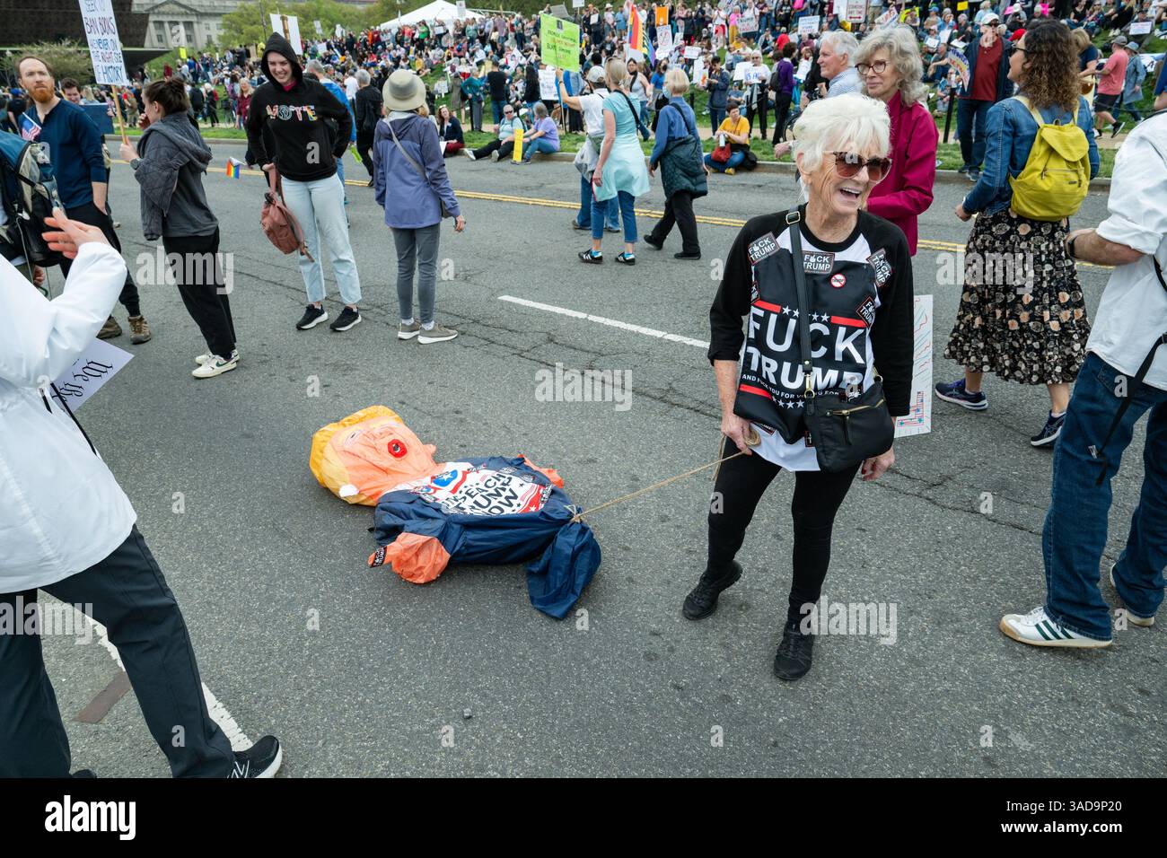 Washington, United States. 05th Apr, 2025. A woman dragging a deflated ...
