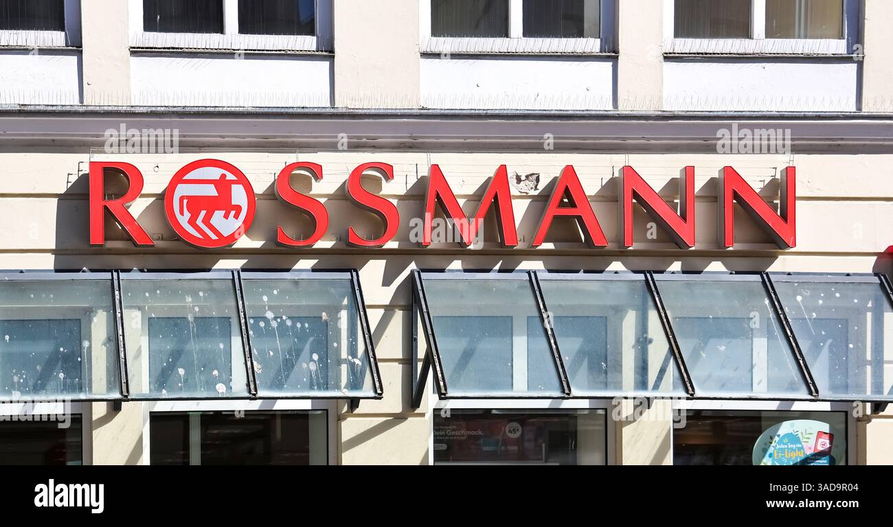 Red Rossmann logo with horse and rider symbol shining above glass ...