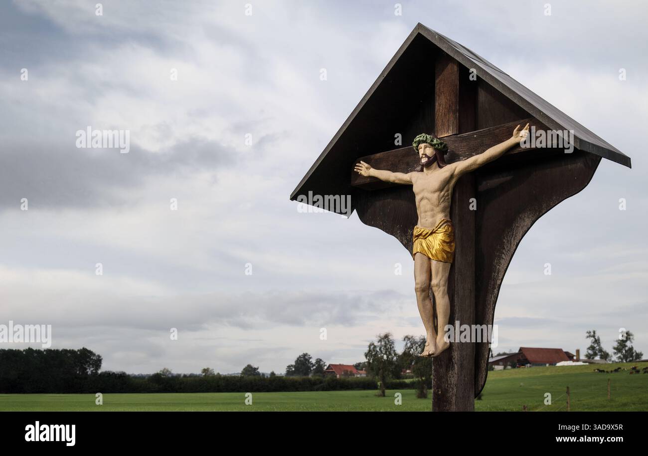 Wooden Crucifix or field cross in countryside. Jesus Christ wearing a ...