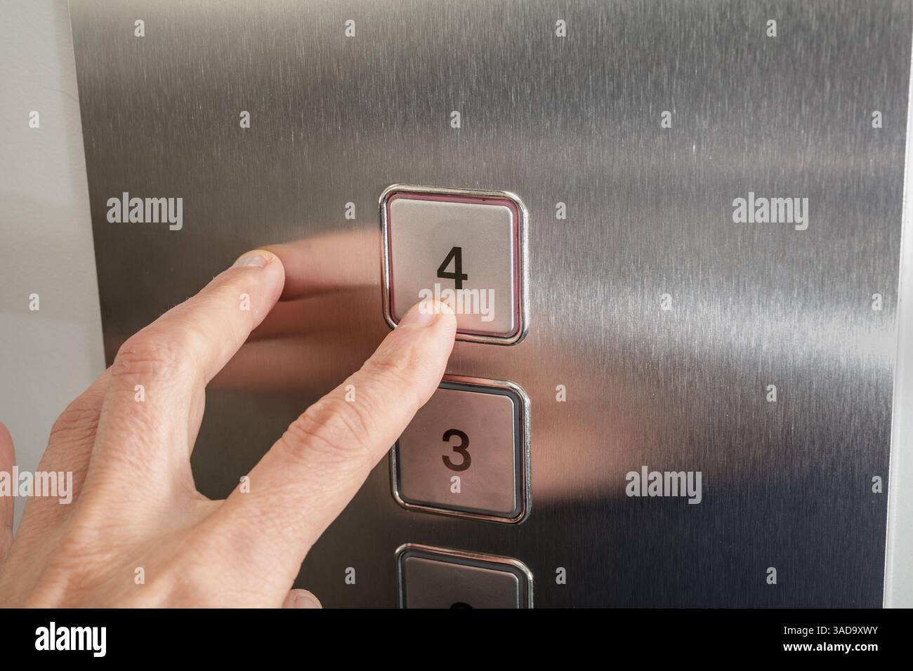 Person pushing elevator button. Female passenger going on level 4 ...