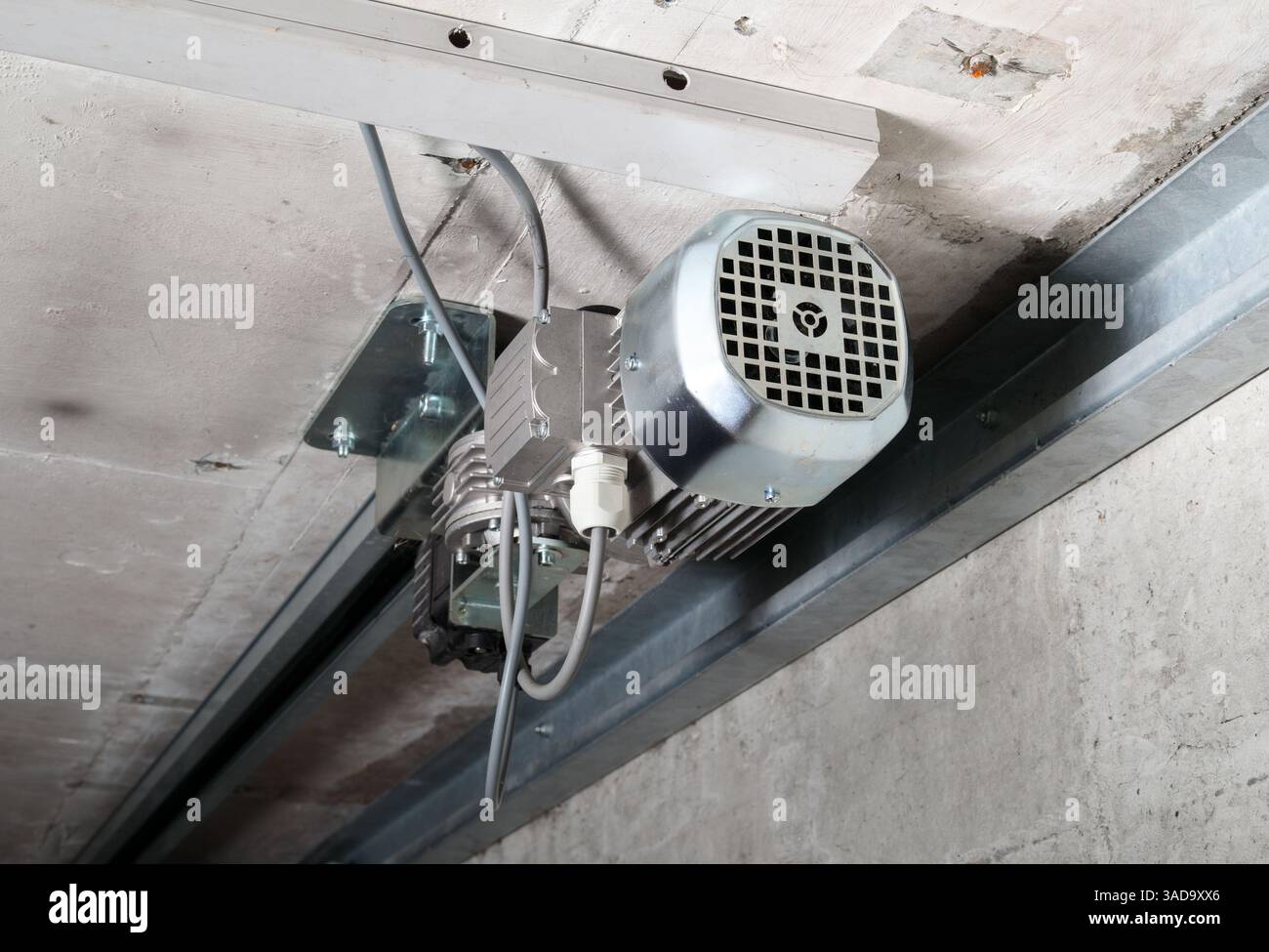 Parking gate engine or motor in parkade or garage of building. Close of ...