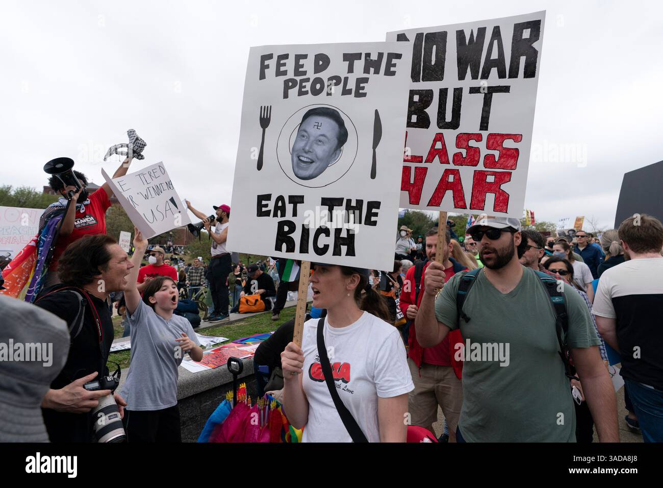 Demonstrators carry signs during the "Hands Off!" protests against ...