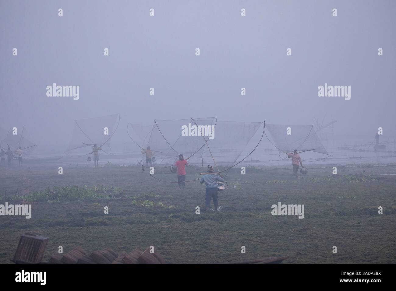 Fishermen make their way to Dikshir Beel on a foggy winter morning to ...