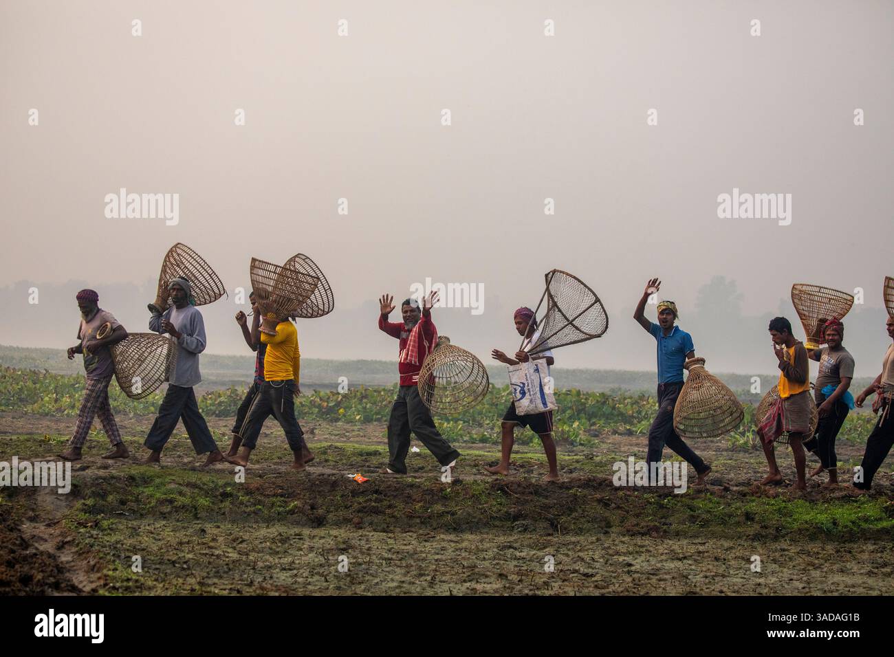 Fishermen make their way to Dikshir Beel on a foggy winter morning to ...