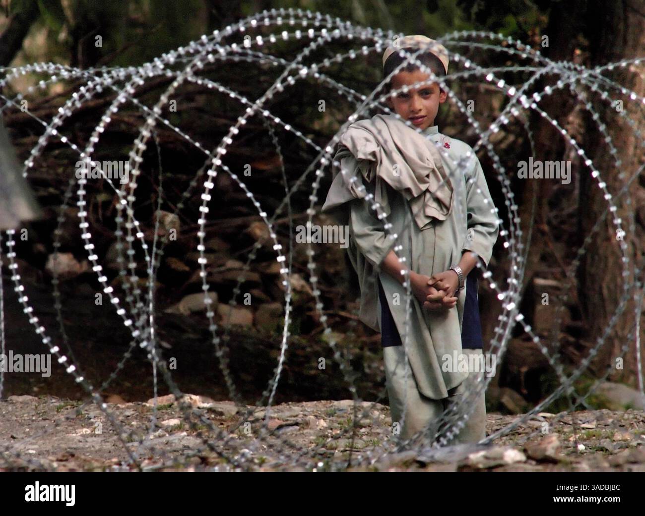 May 25, 2005; Yaqubi, AFGHANISTAN; An Afghan boy looks through razor ...