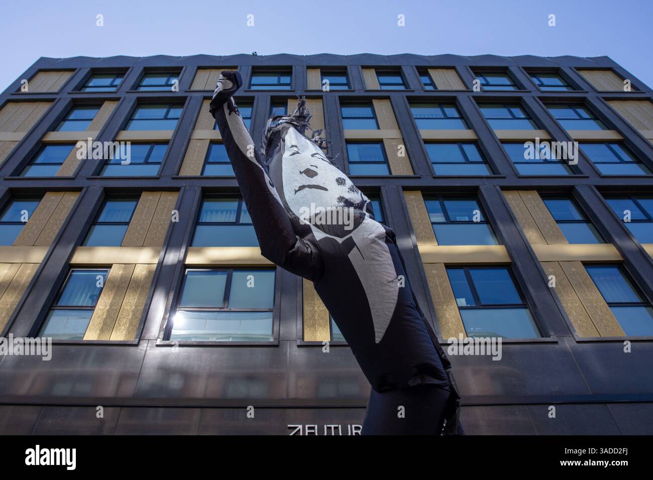An inflatable Elon Musk is inflated in-front of an office block during ...