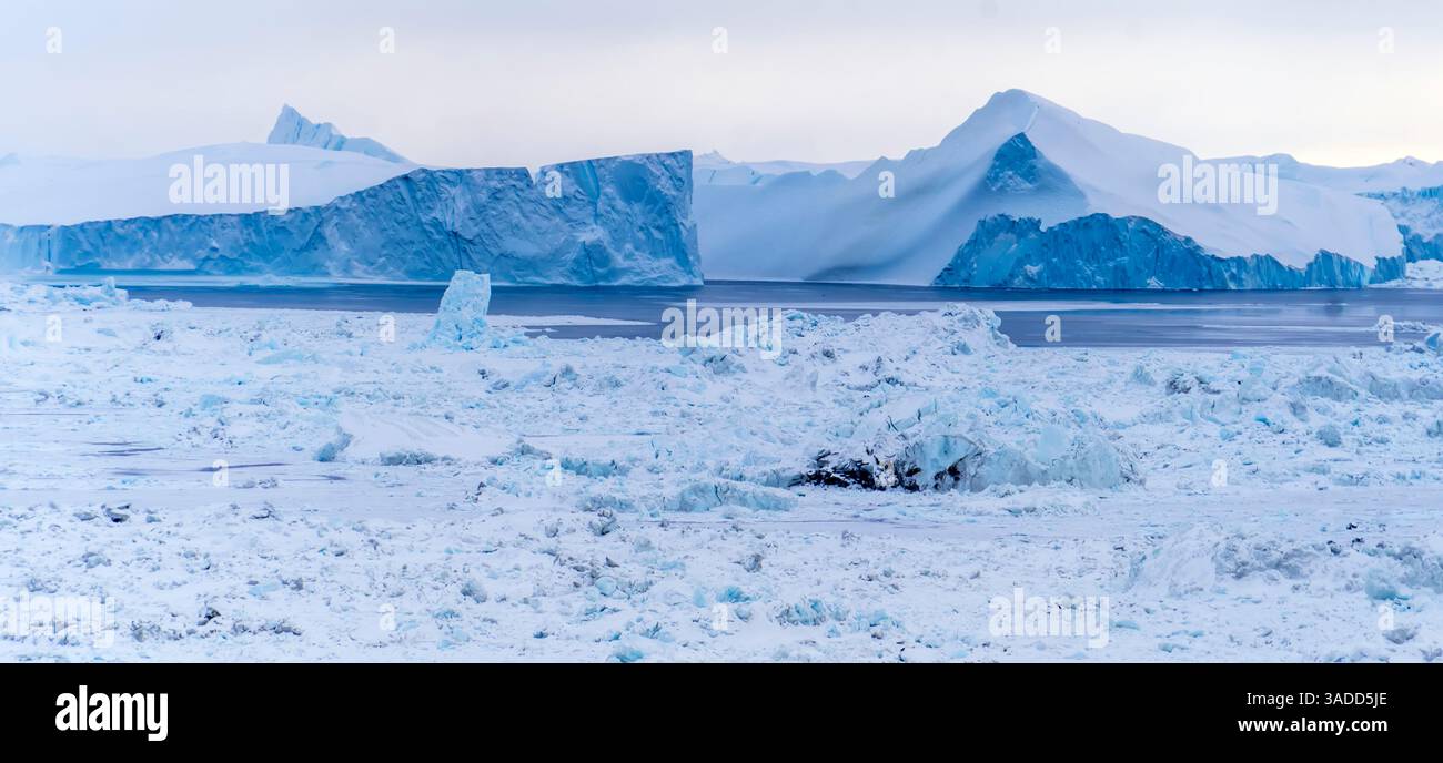 A stunning icy landscape featuring massive glaciers and icebergs in a ...