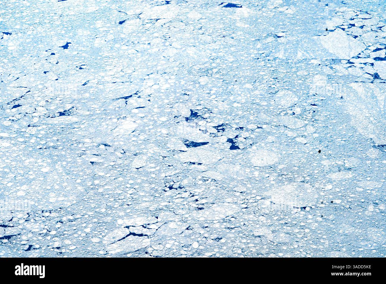 Aerial view of fragmented ice on a blue water surface, showcasing ...