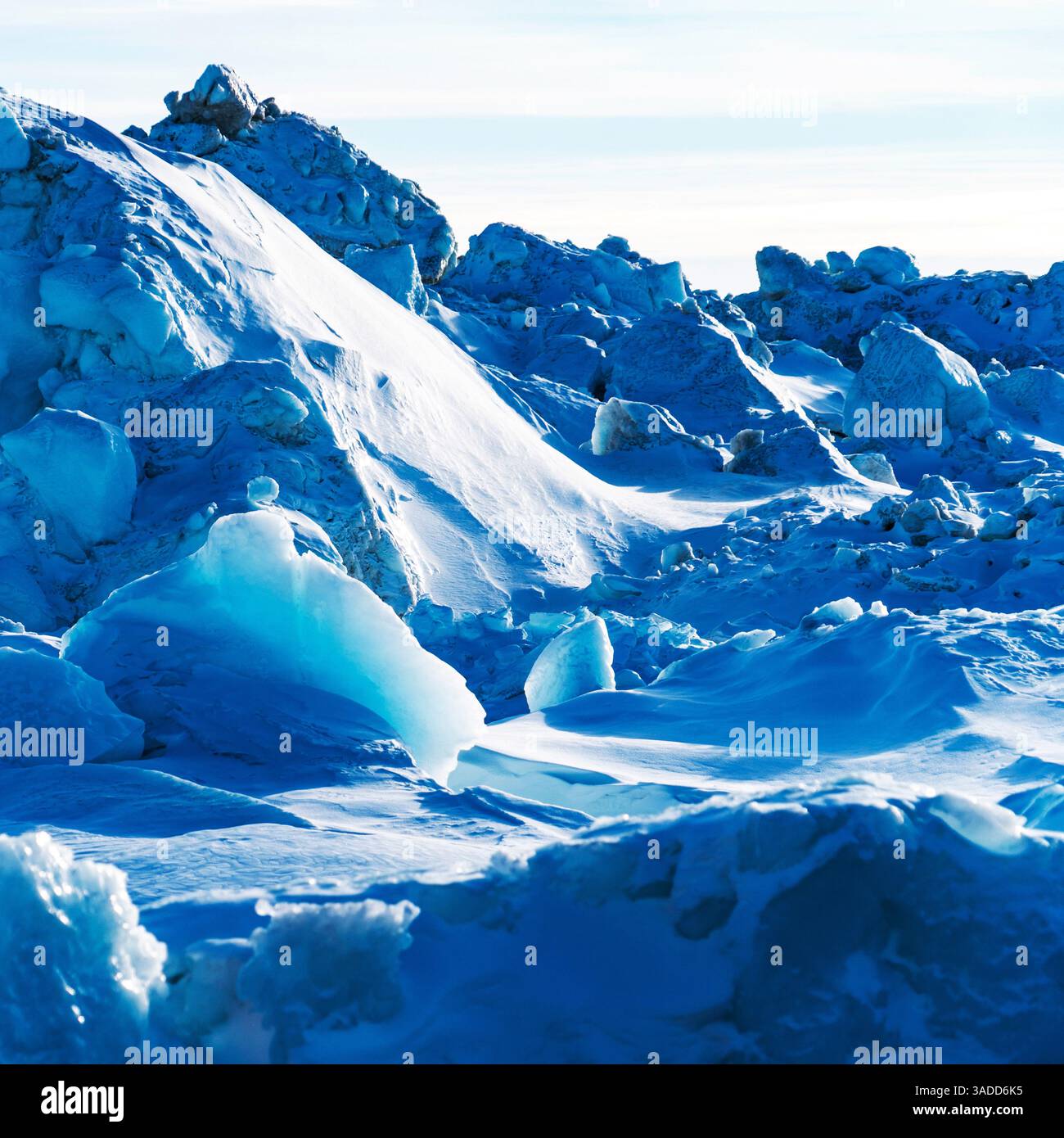 A stunning icy landscape featuring blue ice formations and snow-covered ...