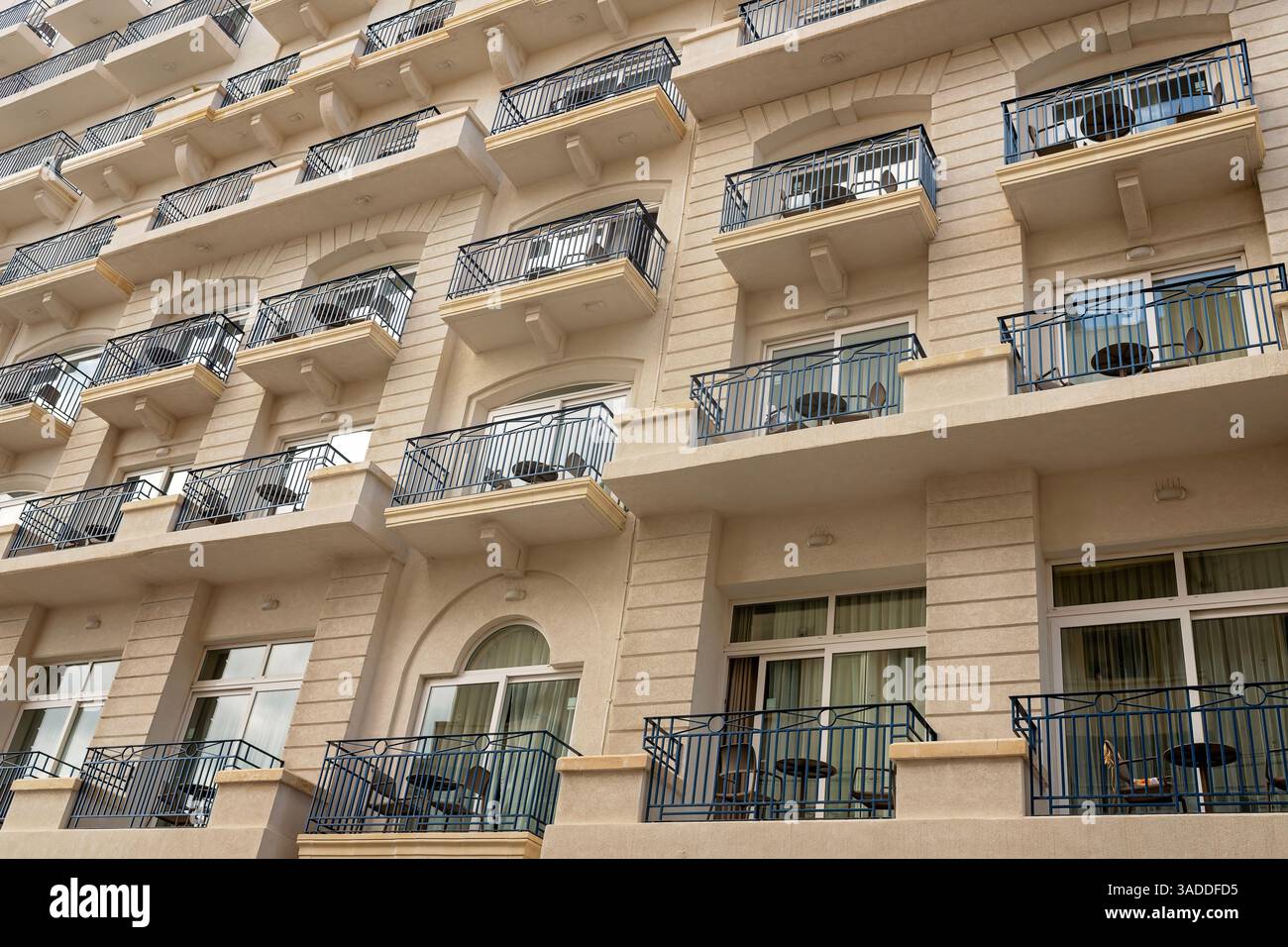 The façade of the beautiful multi-storey building with uniform black ...