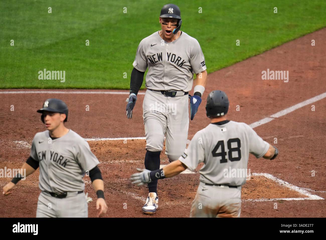 New York Yankees' Aaron Judge, center, Ben Rice, left, and Paul Goldschmidt (48) score on an RBI ...