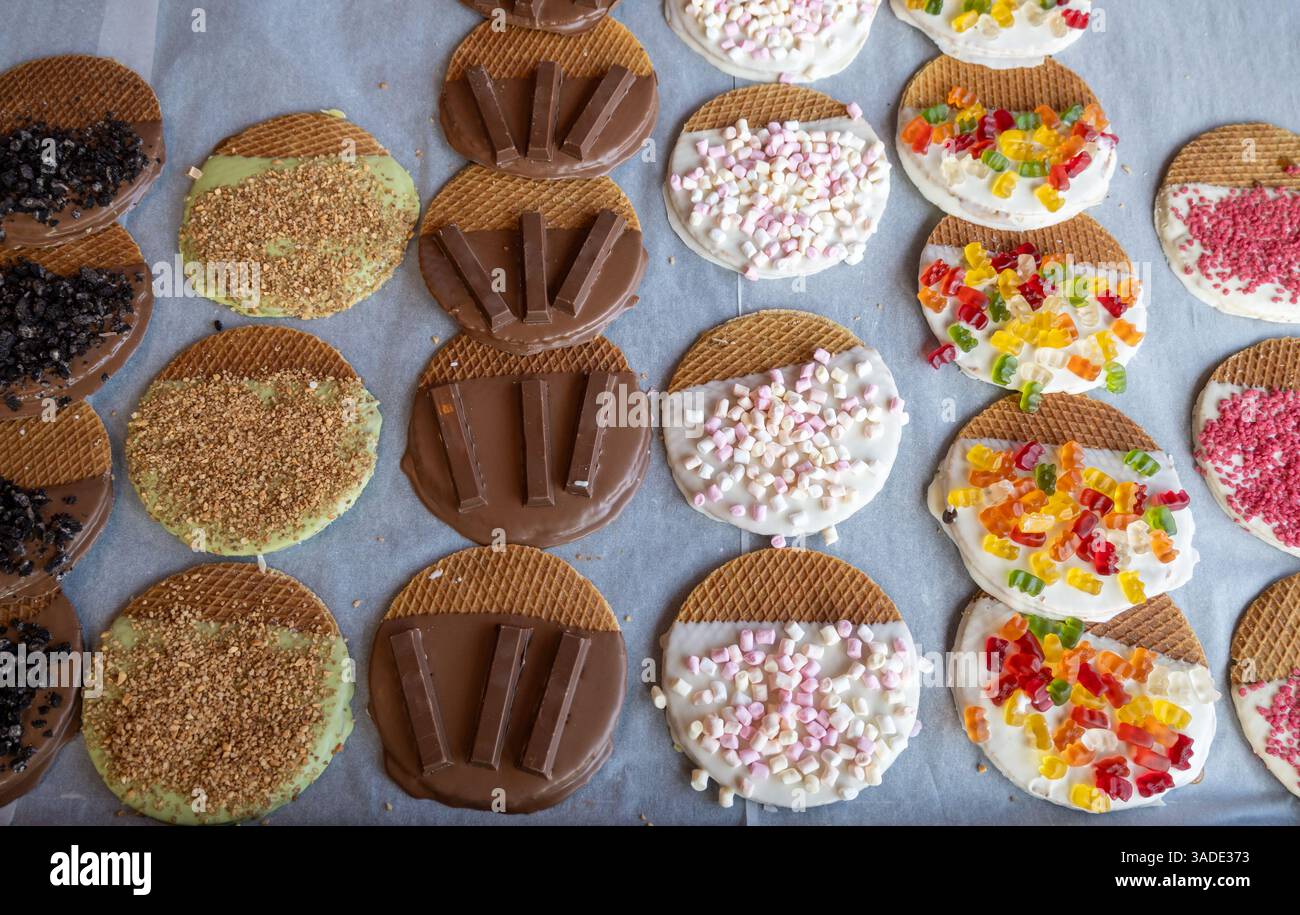 Variety of fresh baked syrop caramel waffles richly decorated with ...