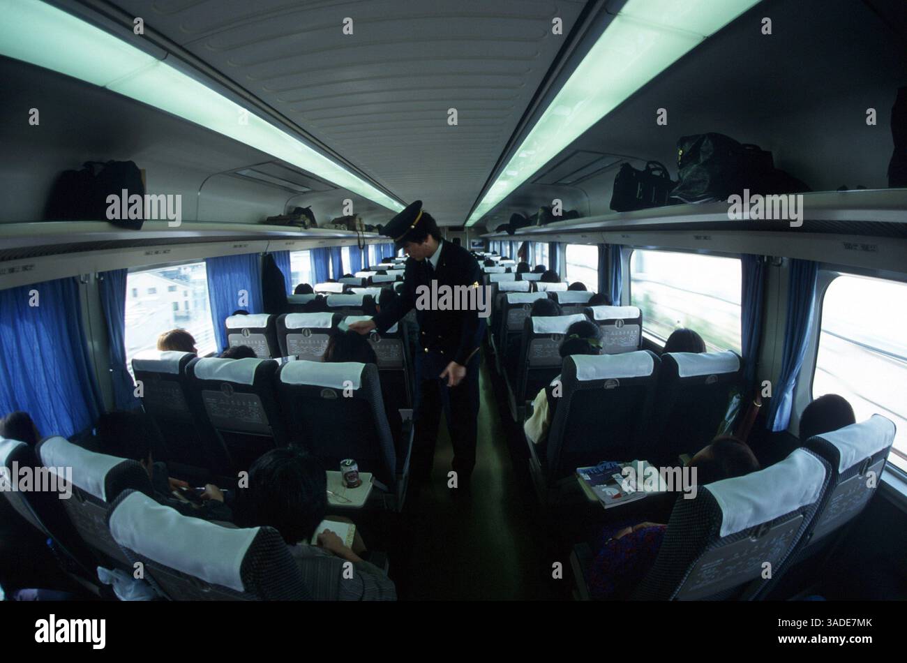 Nov 01, 2000; Tokyo, Japan; A train attendant checks tickets on a ...