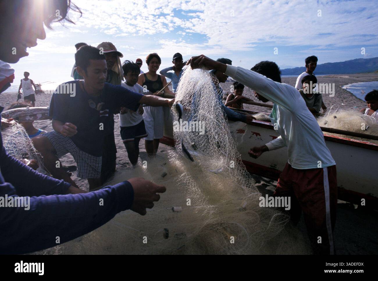 May 05, 2001; Manila, Bataan, Philippines; Fishers pull fish from Gill ...