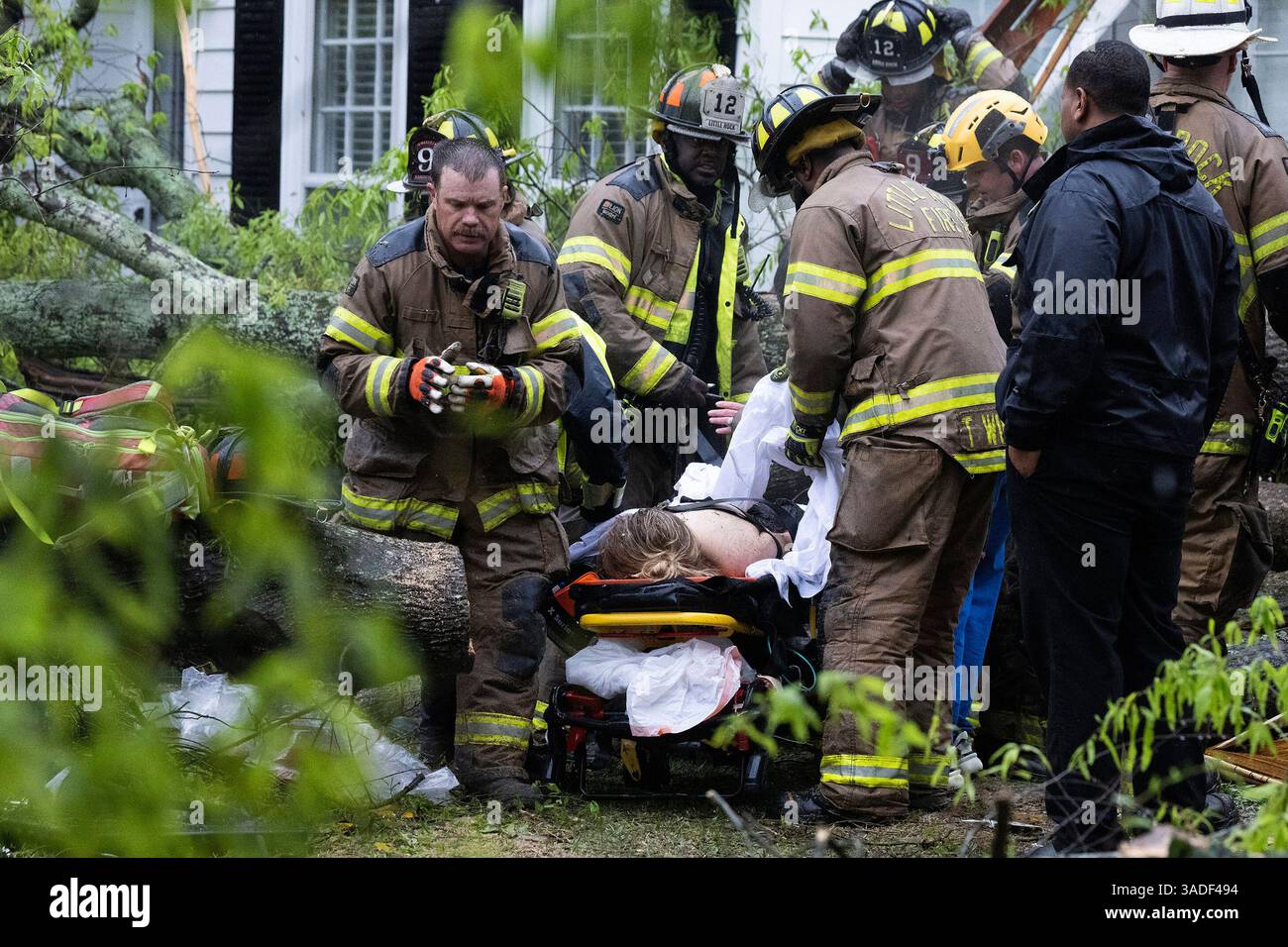 First responders tend to a women who was trapped under debris after a ...