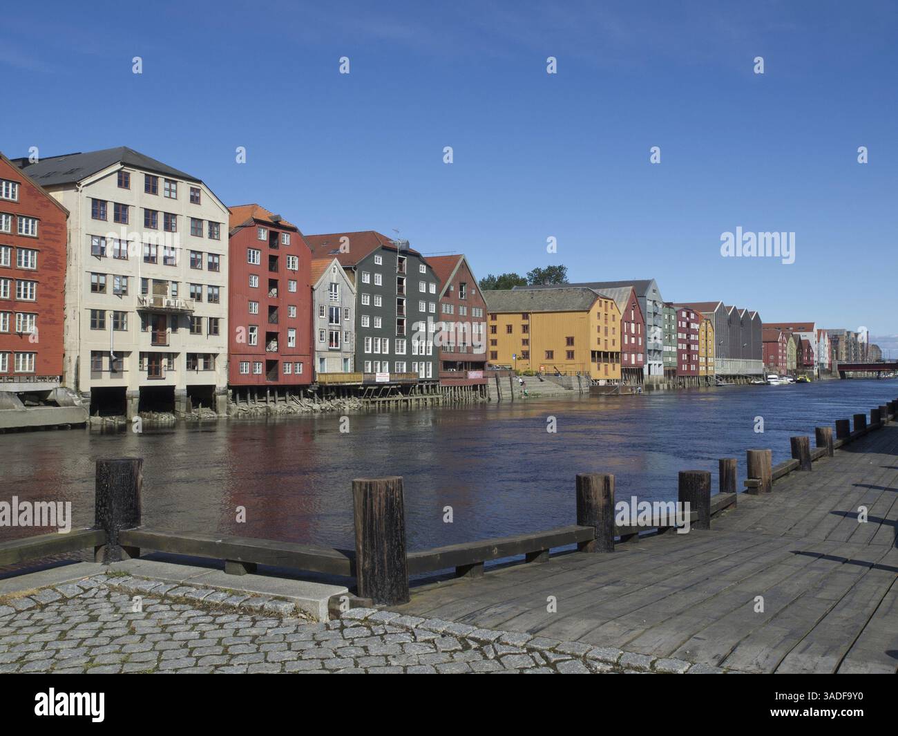 Row of coloured houses along a waterfront promenade, trondheim, norway ...