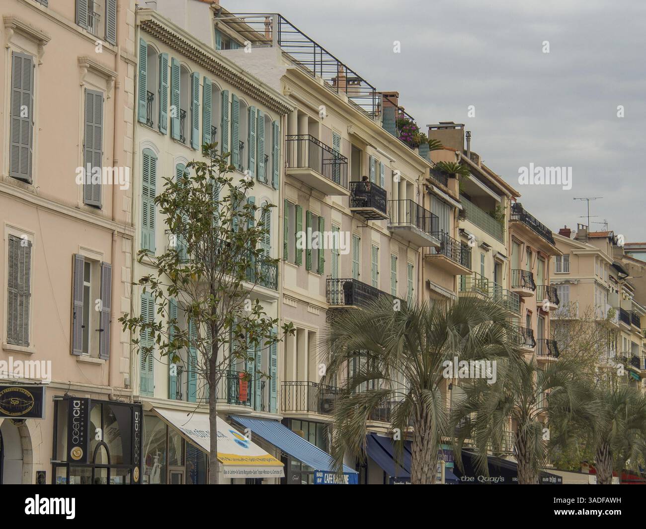 City view with classic buildings, stylish shutters and trees, cannes ...