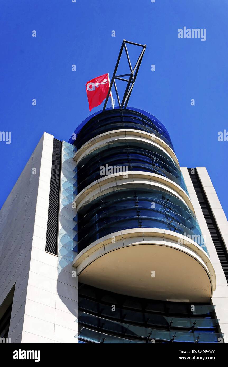 Red SPD flag flies on a modern building under a clear blue sky, Willy ...