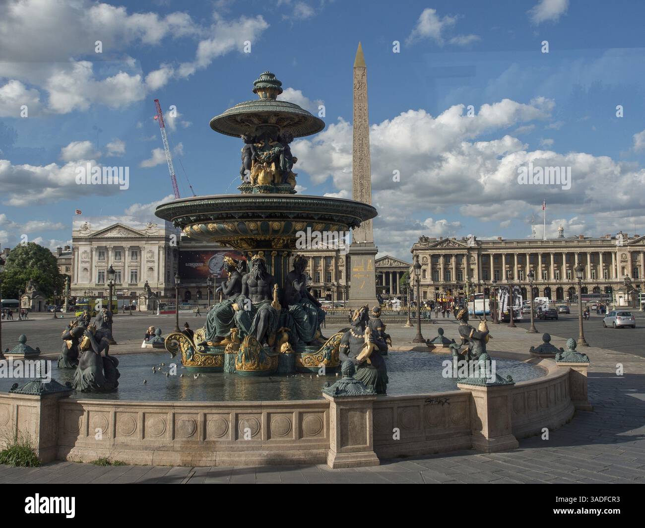 Magnificent fountain with sculptures on a lively square under a blue ...