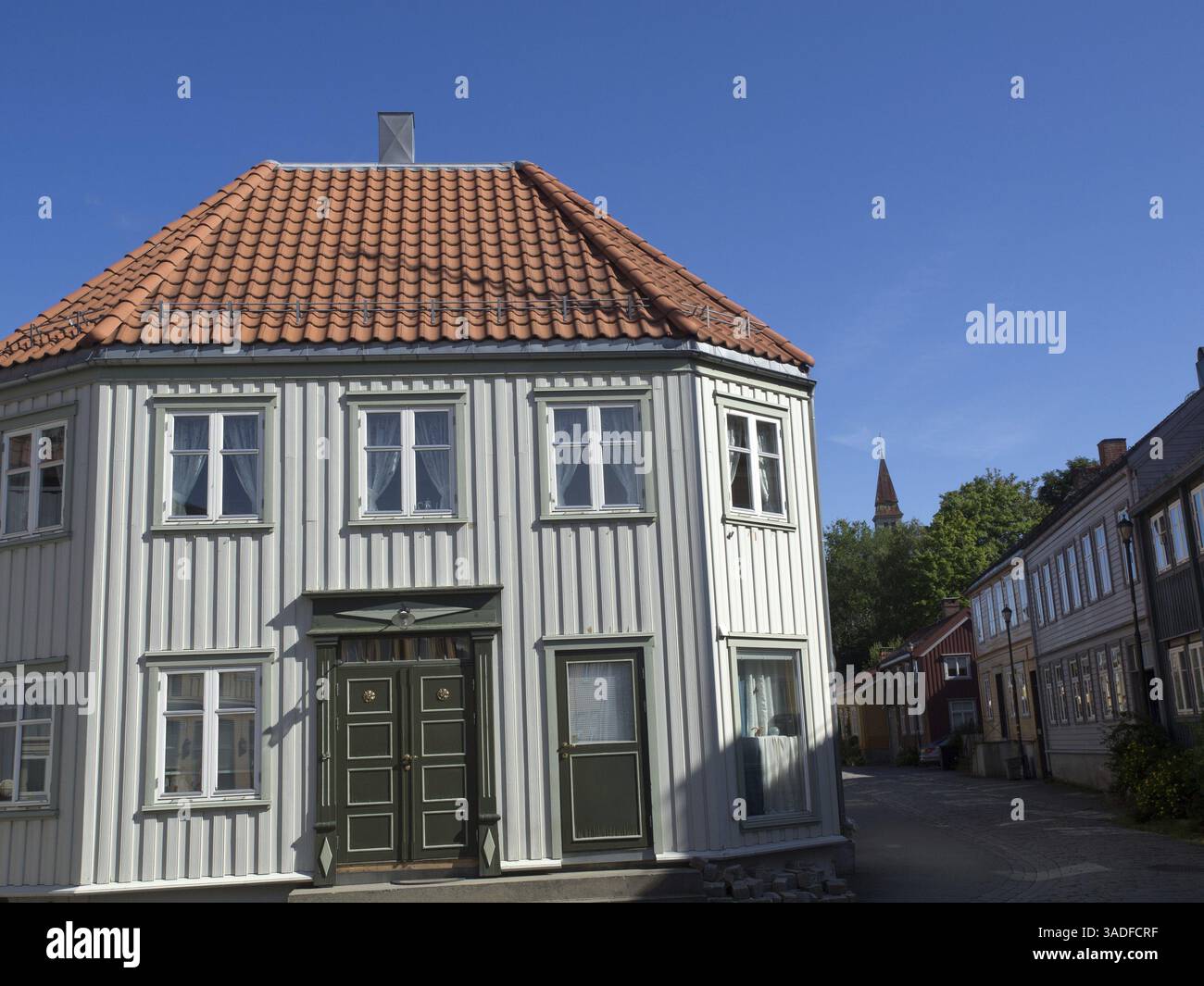 Traditional house with tiled roof and wooden facade in a street ...