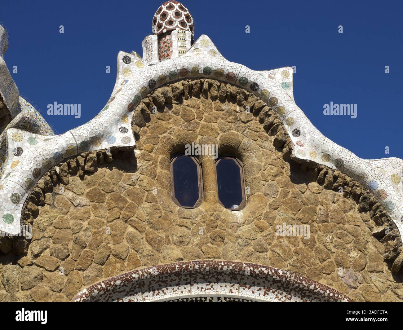 Detail of the stone structure with two windows and decorative mosaic ...