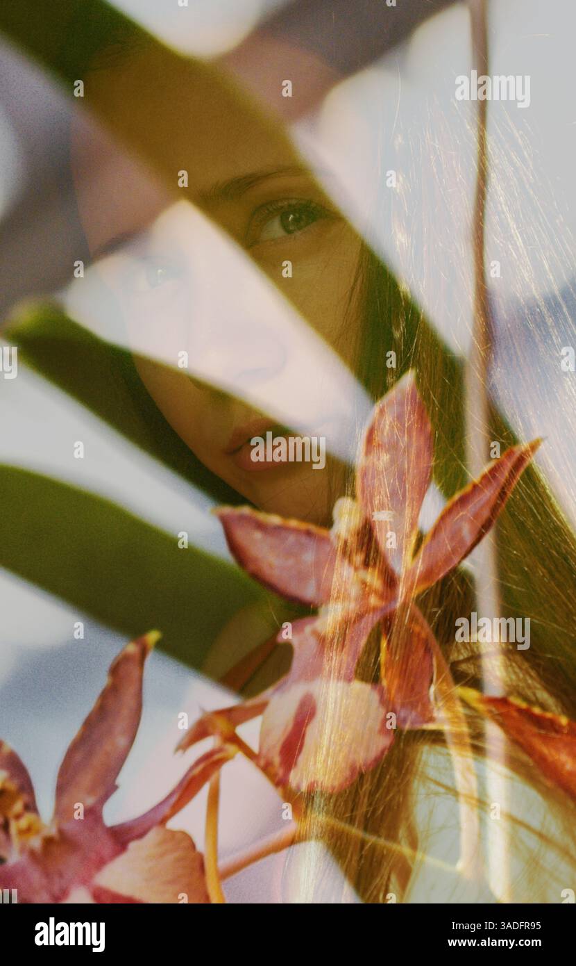 Female portrait with overlay of tropical orchids flowers, palm trees on ...