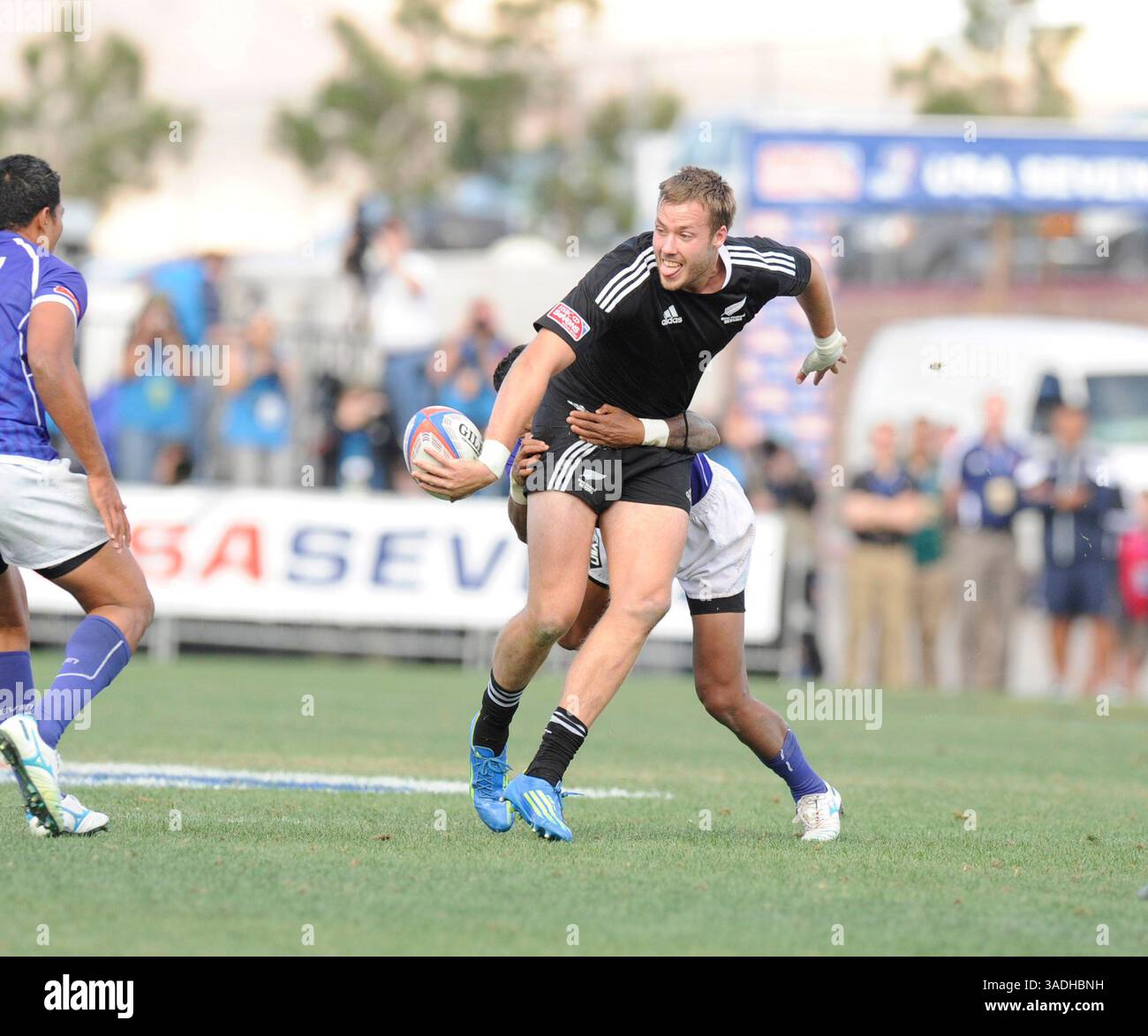 2012 FEB 12: New Zealand's Tim Mikkelson passes the ball behind his ...