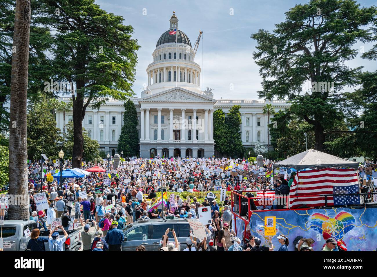 The California Capitol building with U.S. flag with large crowd at the ...