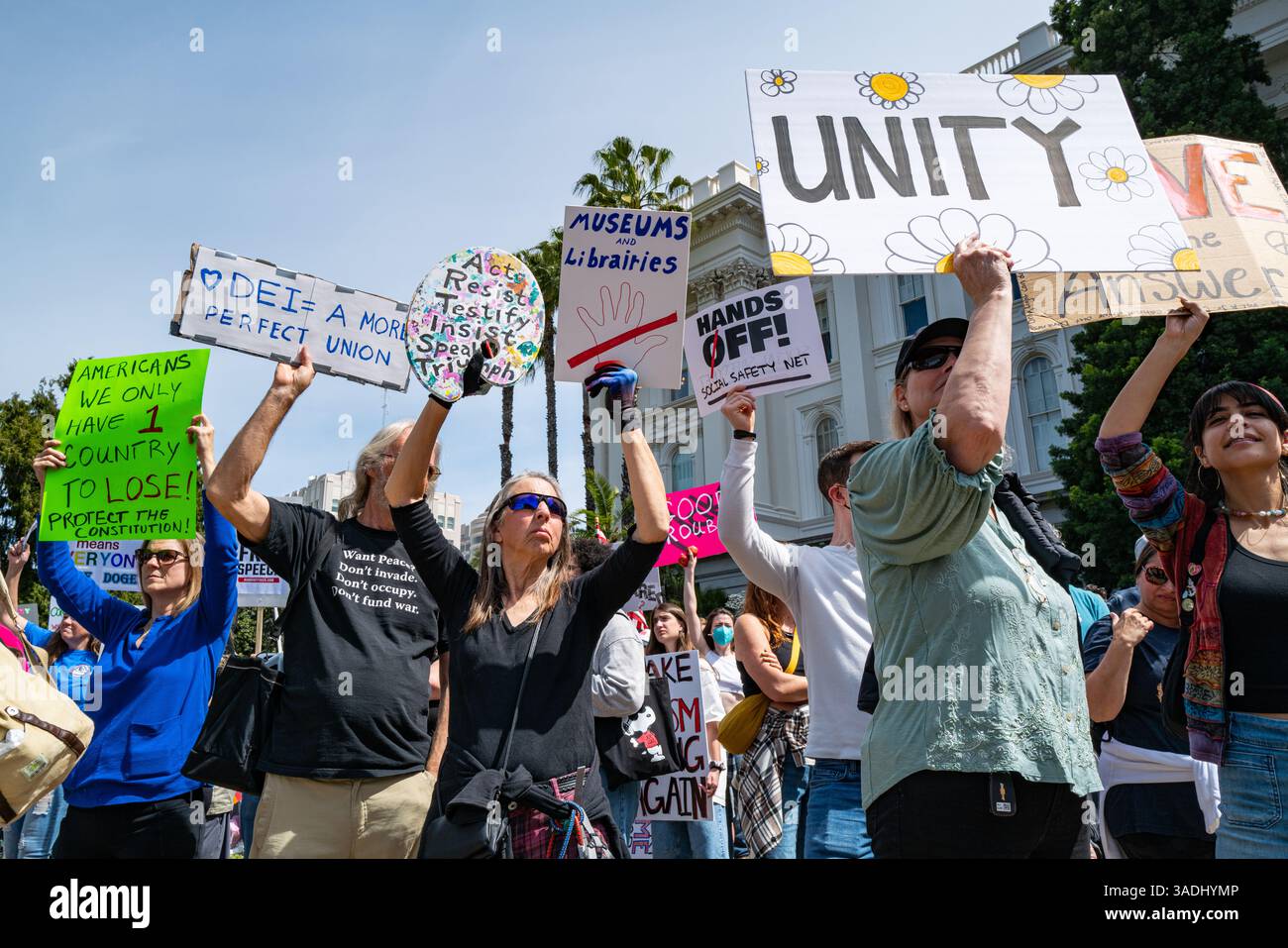Participants hold various signs about hands off unity, museums ...