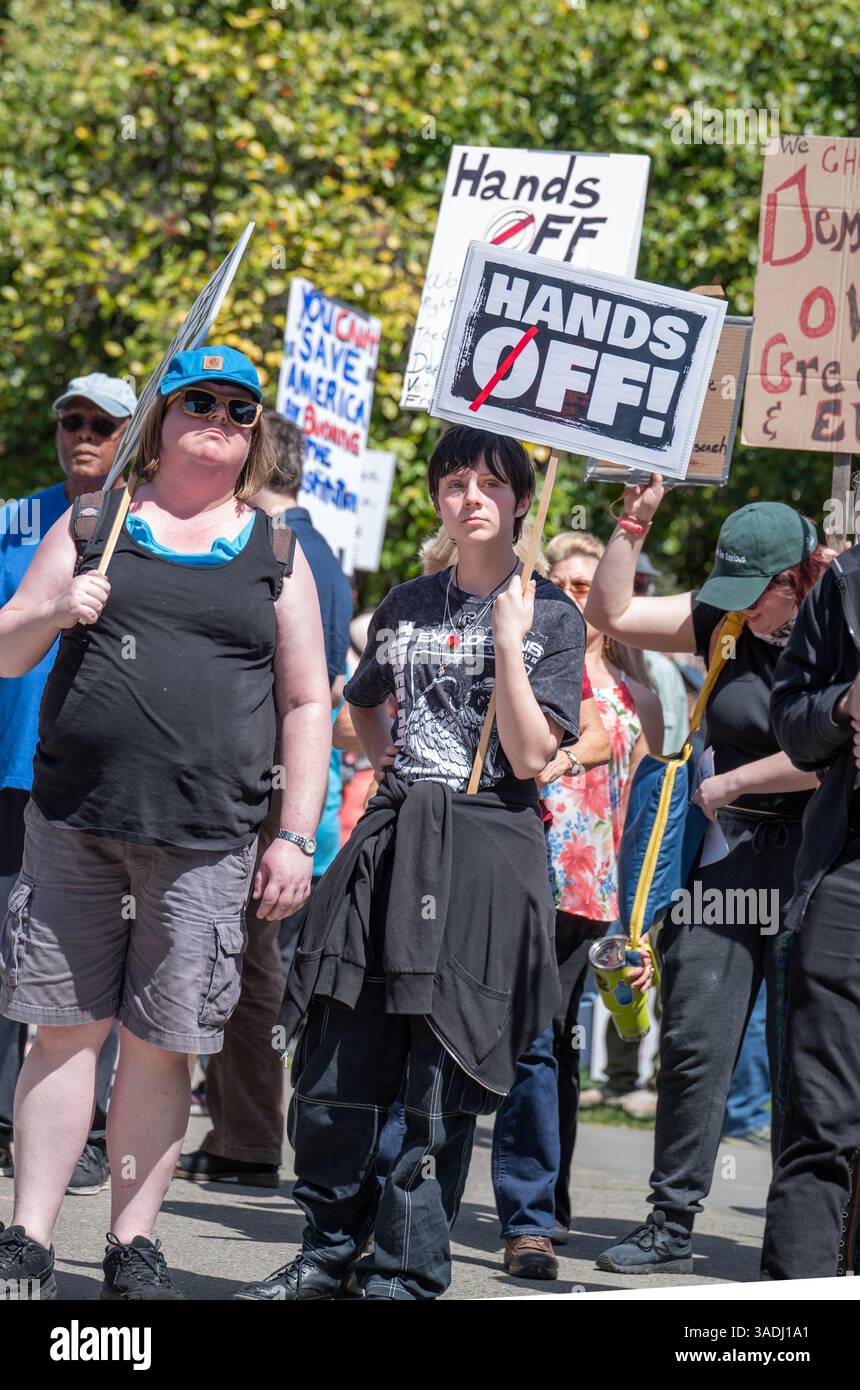 Protesters hold Hands off signs at the 50501 Hands-Off protest, held ...
