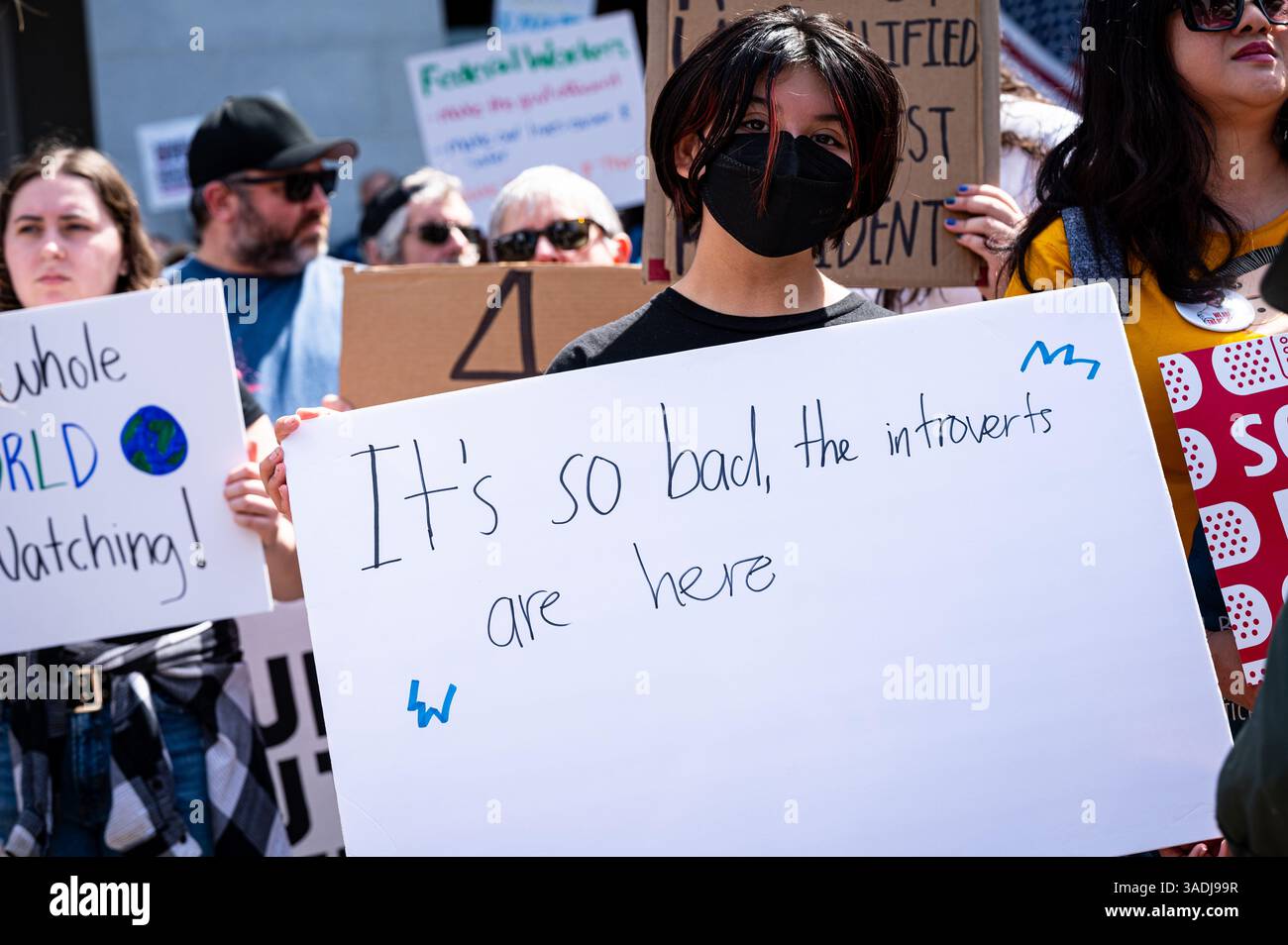 A participant at the 50501 Hands-Off protest holds a humorous sign ...