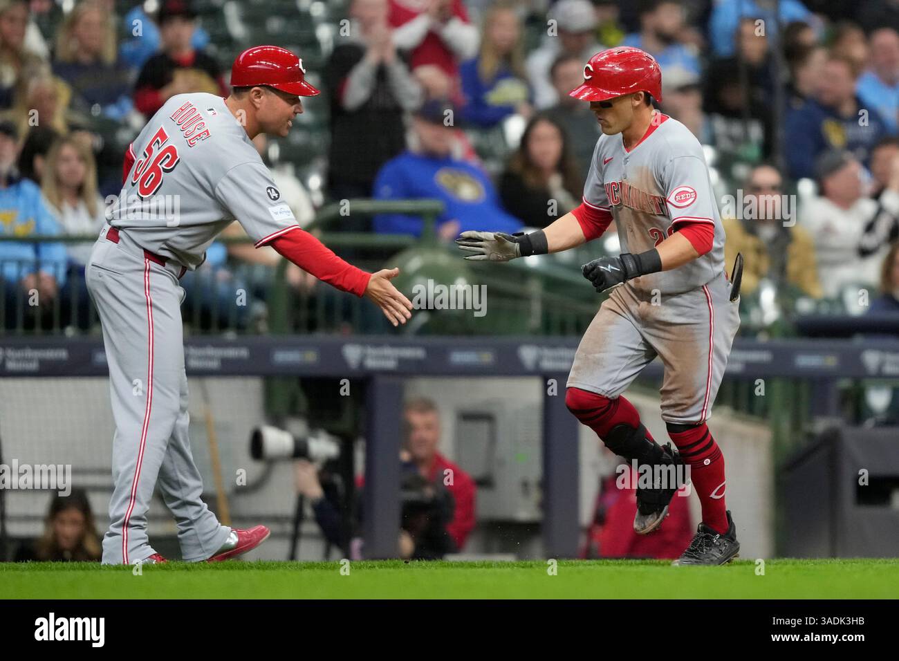 Cincinnati Reds' TJ Friedl high-fives J.R. House (56) as he rounds the ...
