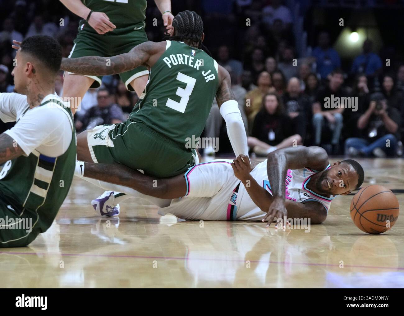 Miami Heat forward Haywood Highsmith, right, loses control of the ball ...