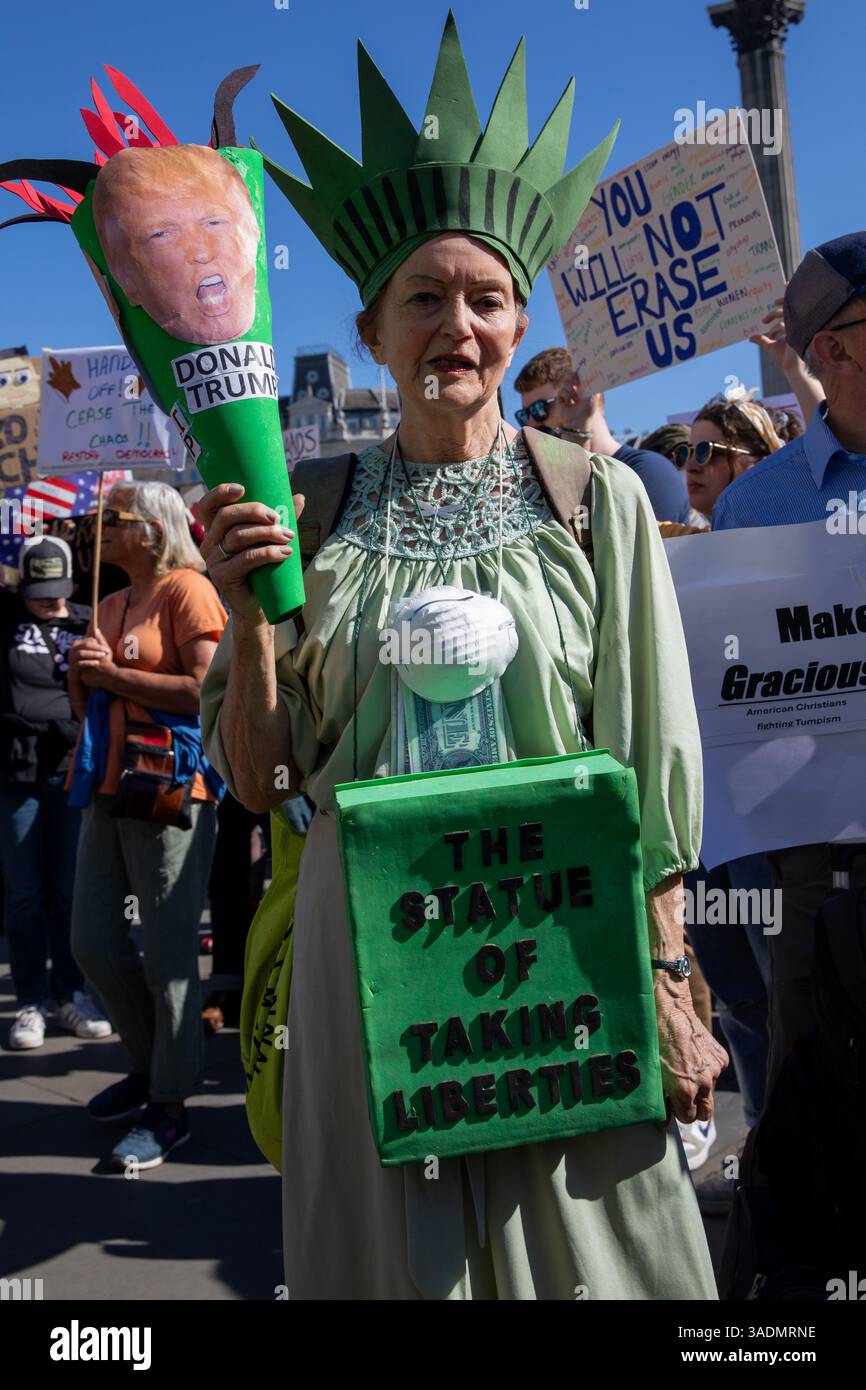 A protestor dressed as the Statue of Liberty holds a placard during an ...