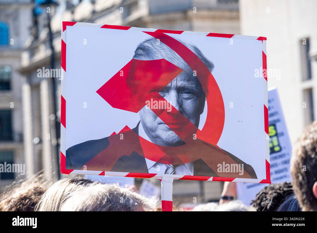 London, UK. 05th Apr, 2025. A protester holds a placard with the US ...