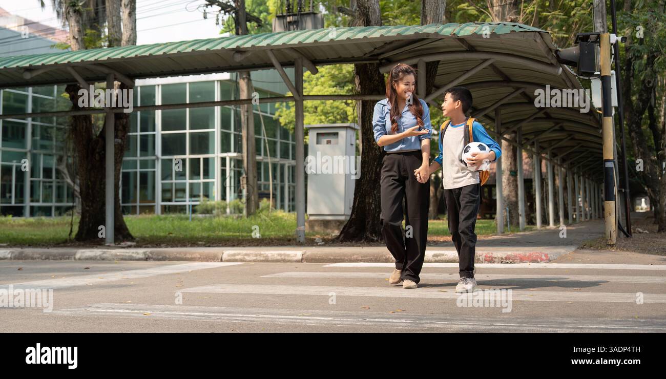Back to School and Soccer Fun. A mentor and student cross a street ...