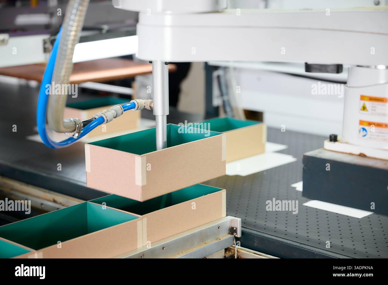 Innovative robotics streamlines gluing process in cardboard box ...