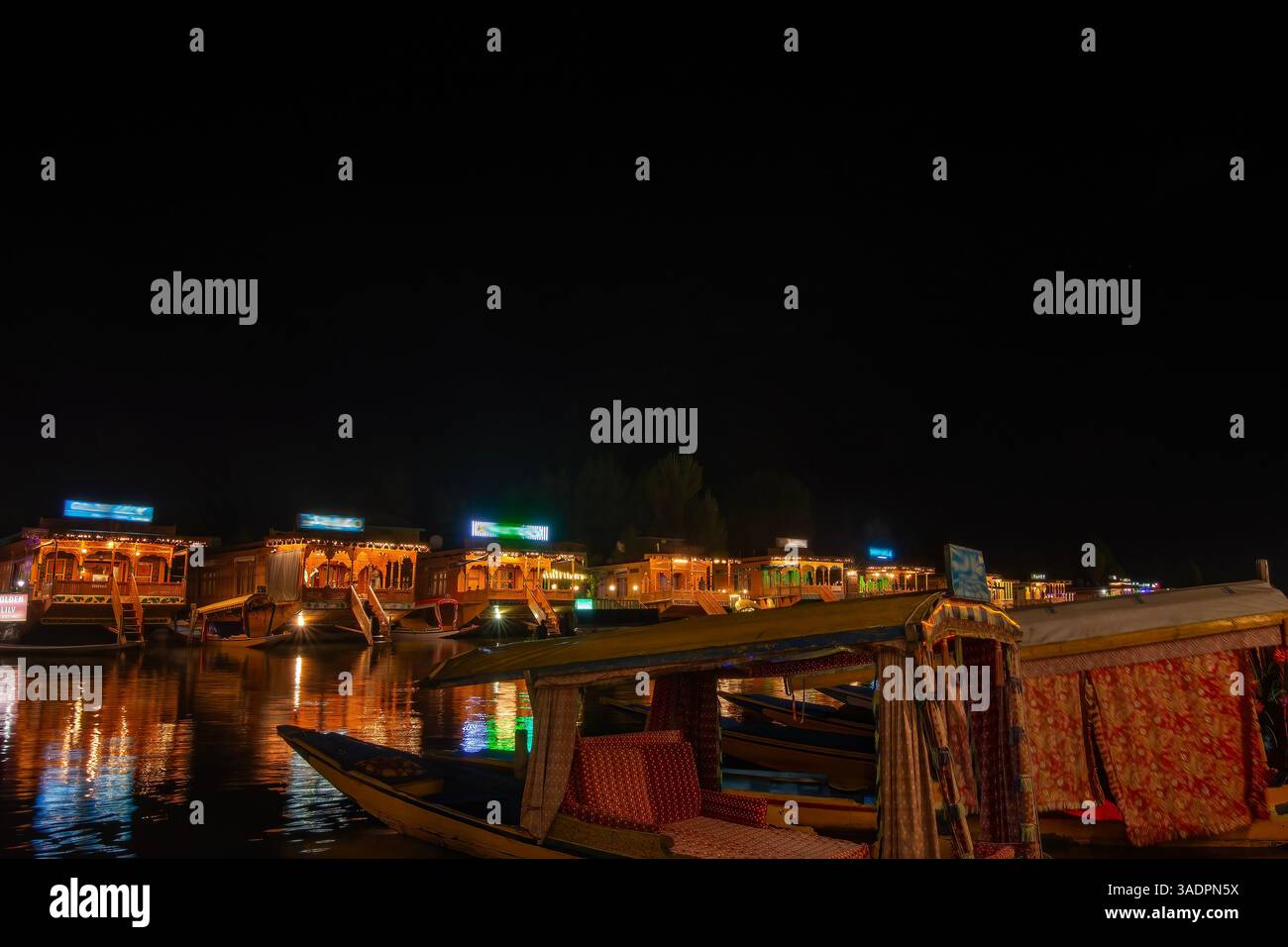 A late night view of the illuminated floating houseboats on Dal lake in ...