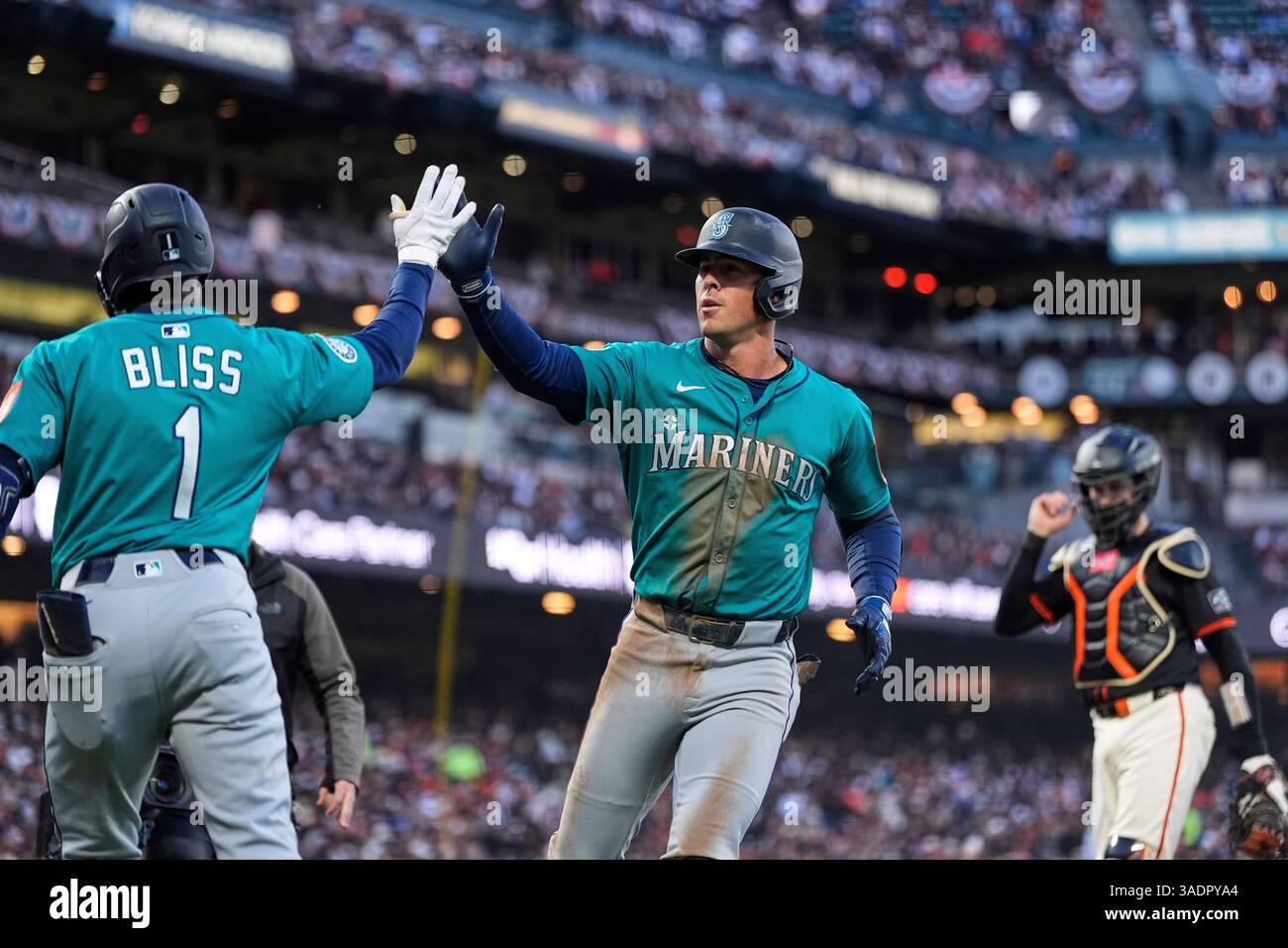 Seattle Mariners' Dylan Moore, center, celebrates with Ryan Bliss (1 ...