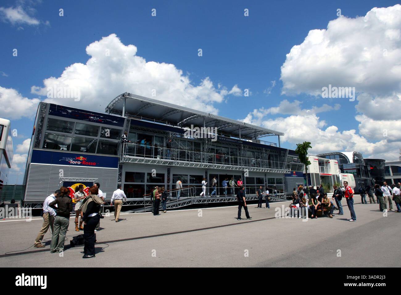 Fluffy clouds above the Red Bull Energy Station in the paddock ...