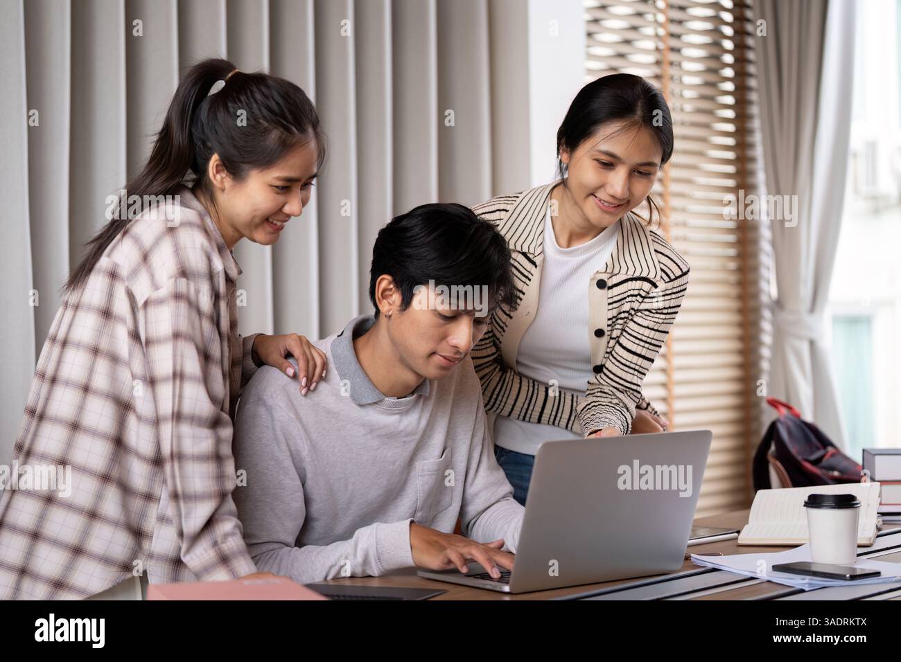 Studying Together and Exploring Ideas. Three friends discussing and ...