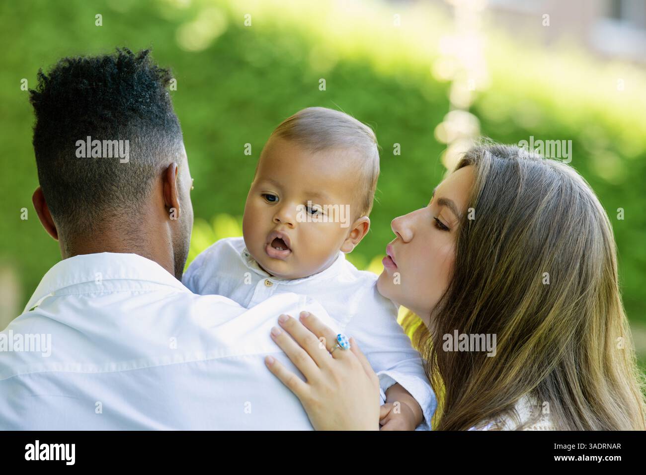 Multiethnic parents Biracial baby in park. Multiracial couple outdoor ...