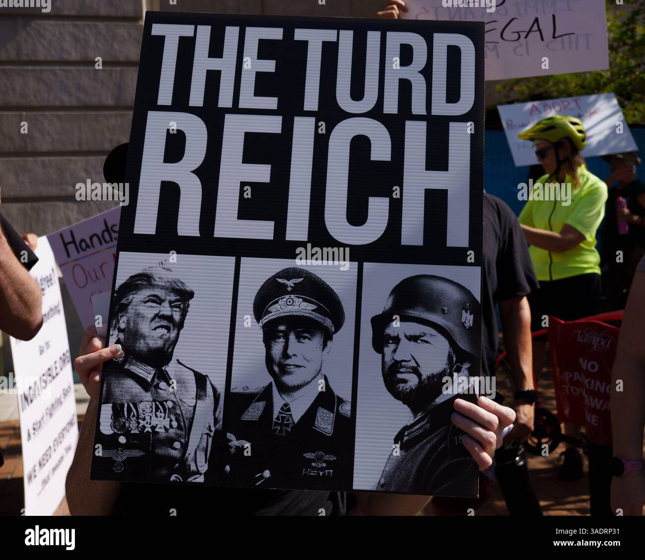 St Petersburg, Florida, USA. 5th Apr, 2025. Protesters hold signs ...