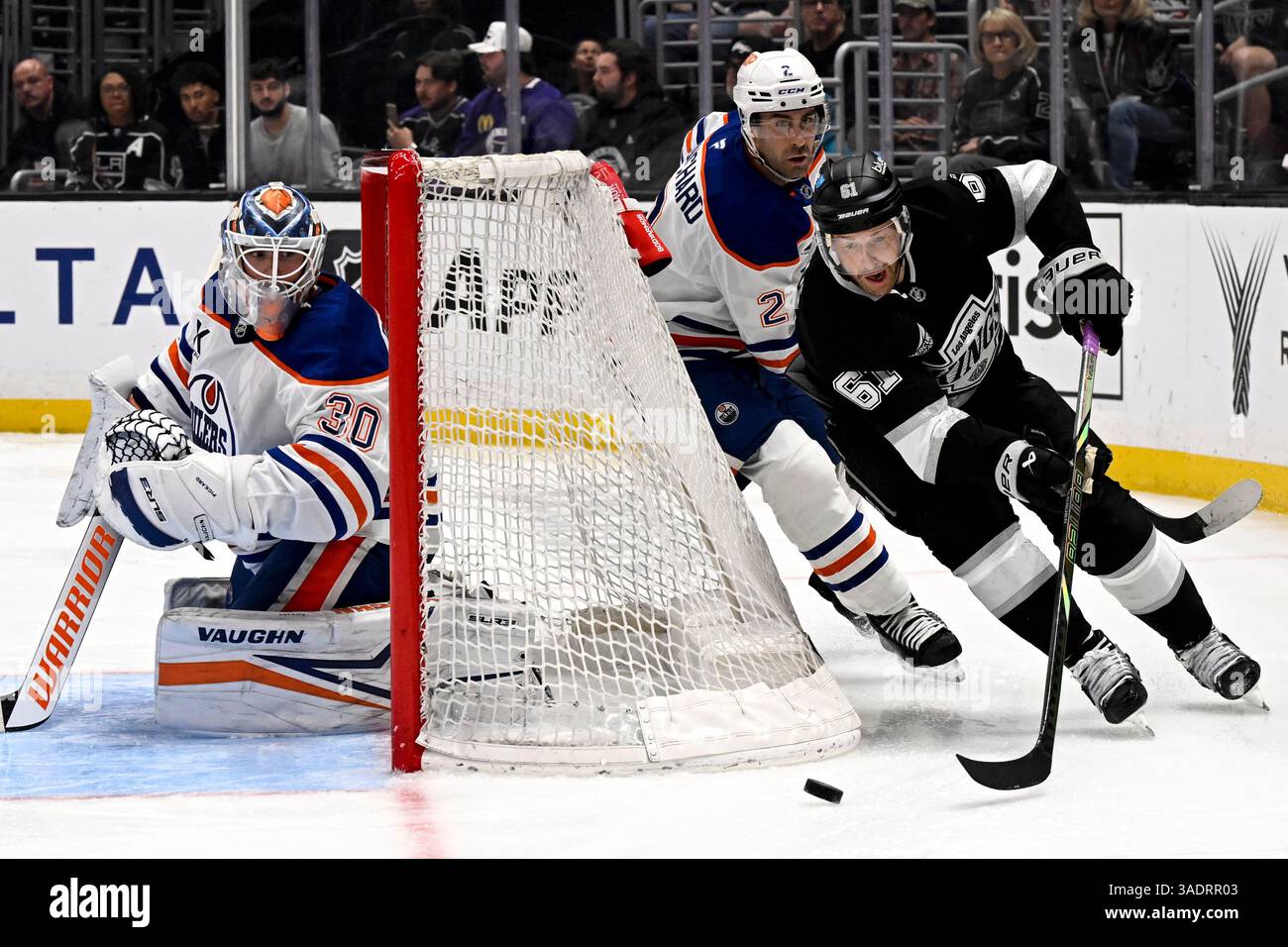 Los Angeles Kings center Trevor Lewis (61) controls the puck against ...