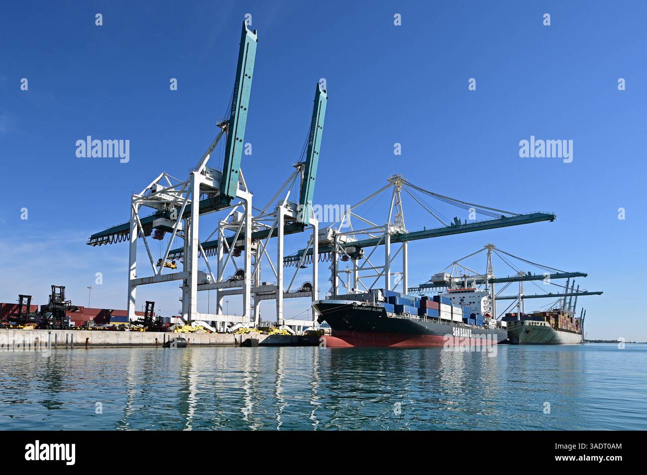 Miami, Florida - 01-29-2025: Cargo ships being loaded with containers ...