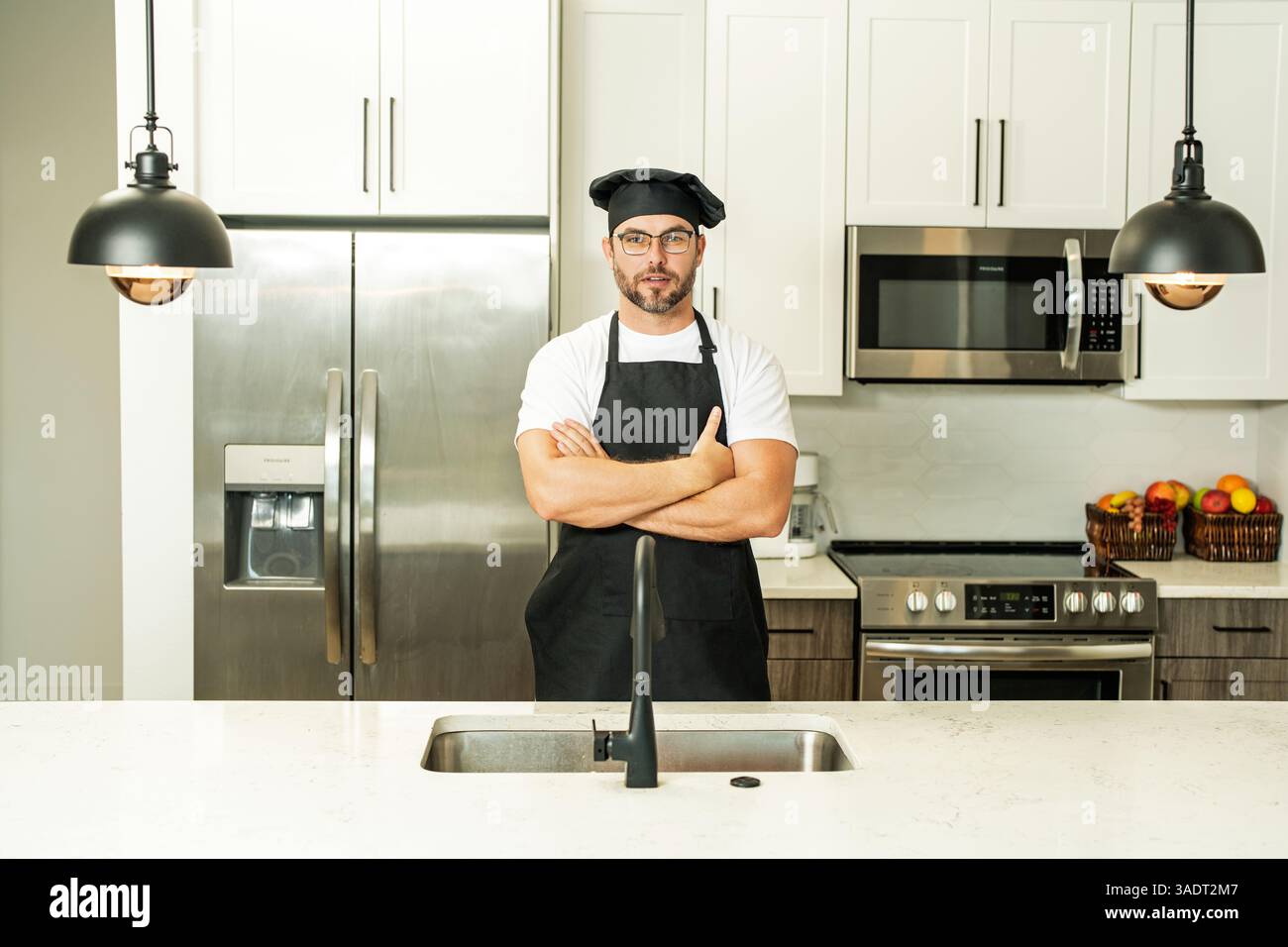 Chef on kitchen. Professional chef man in uniform on kitchen. Bearded ...