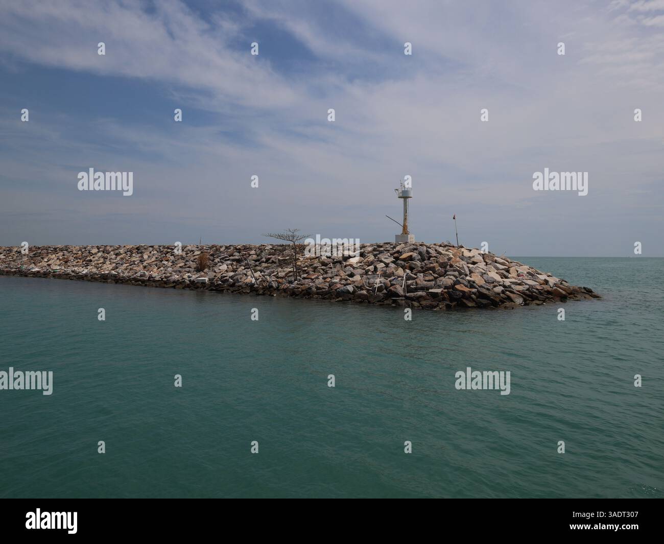 A beautiful coastal jetty featuring a lighthouse stands under the clear ...